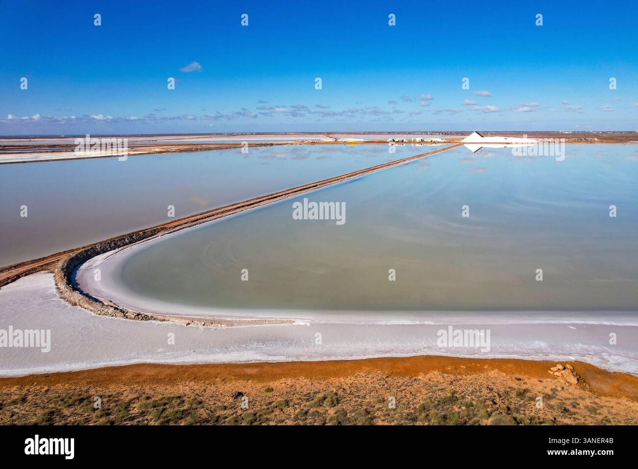 Aerial view of redbank salt farm with tranquil water and blue sky ...