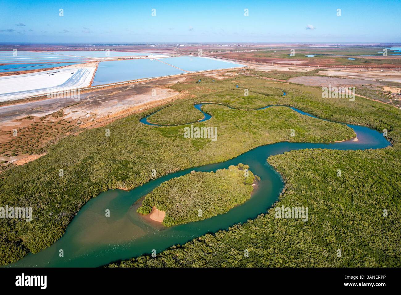 Aerial view of winding river meandering through lush greenery and ...