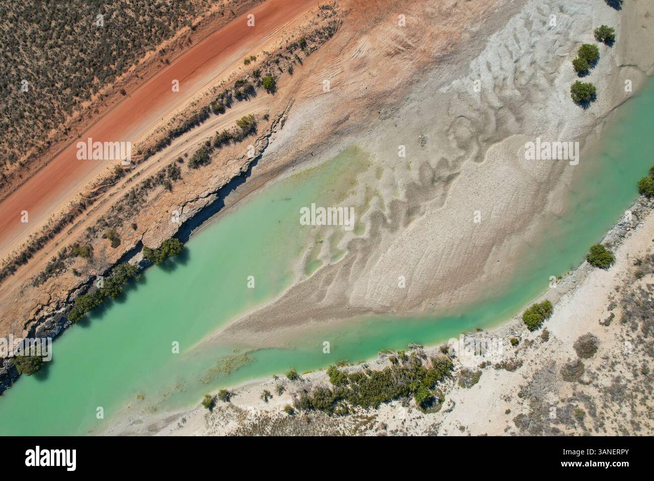 Aerial view of the barren landscape with a riverbed and sparse ...