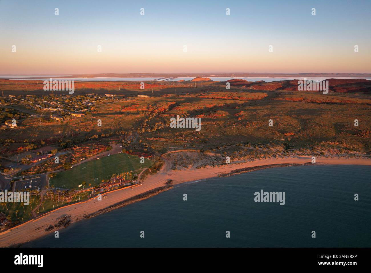 Aerial view of tranquil sunset over the sandy beach and expansive ocean ...