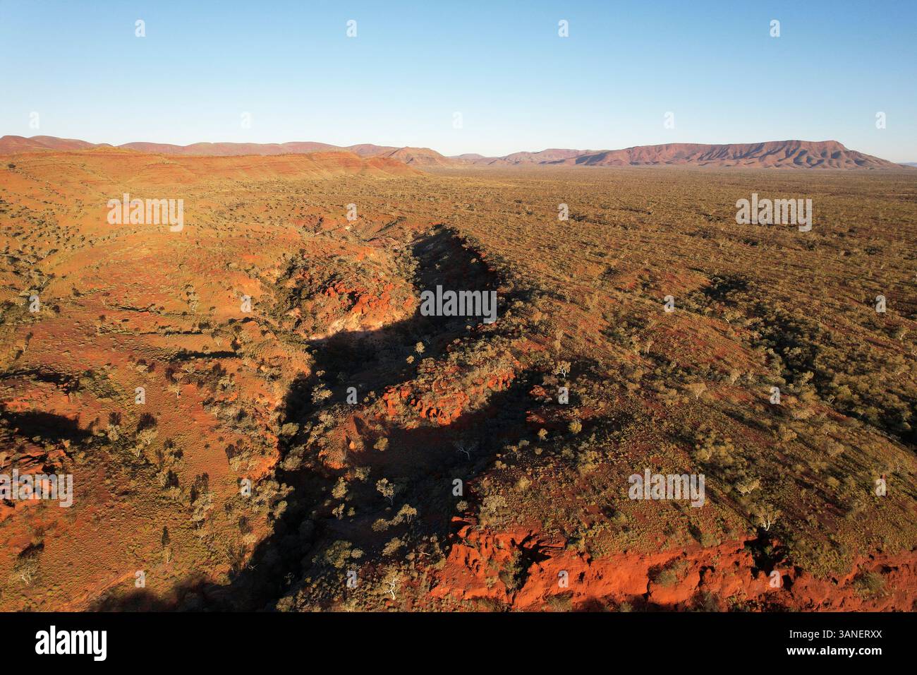 Aerial view of Hamersley Gorge with rugged mountains and a vast desert ...