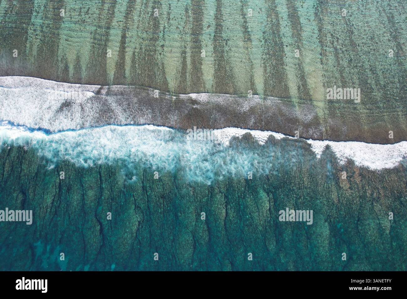 Aerial view of beautiful turquoise ocean and pristine reef with serene ...