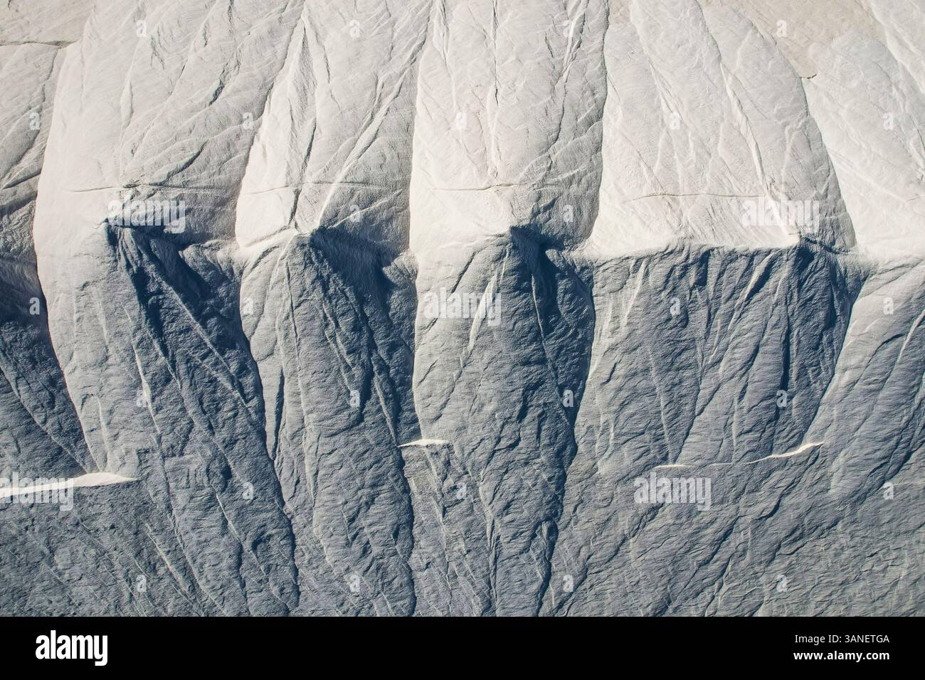 Aerial view of unique salt pile and rugged terrain with dramatic ...