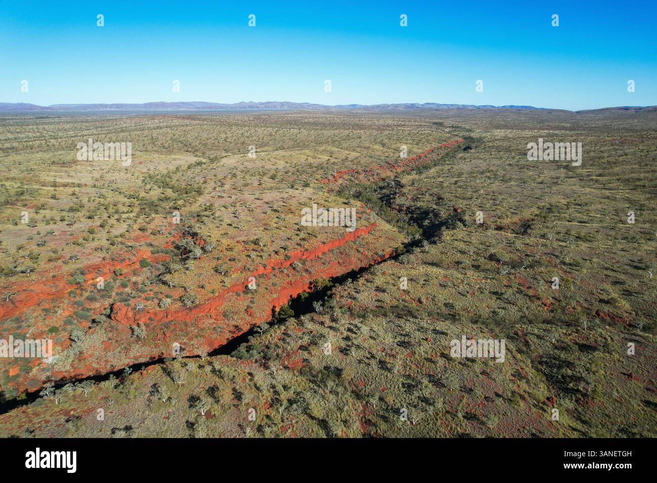 Aerial view of hancock gorge with rugged rock formations and red earth ...