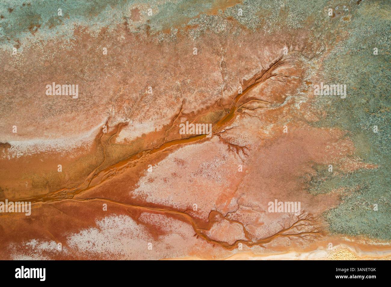 Aerial view of colorful salt pond and creek in the rugged Pilbara ...