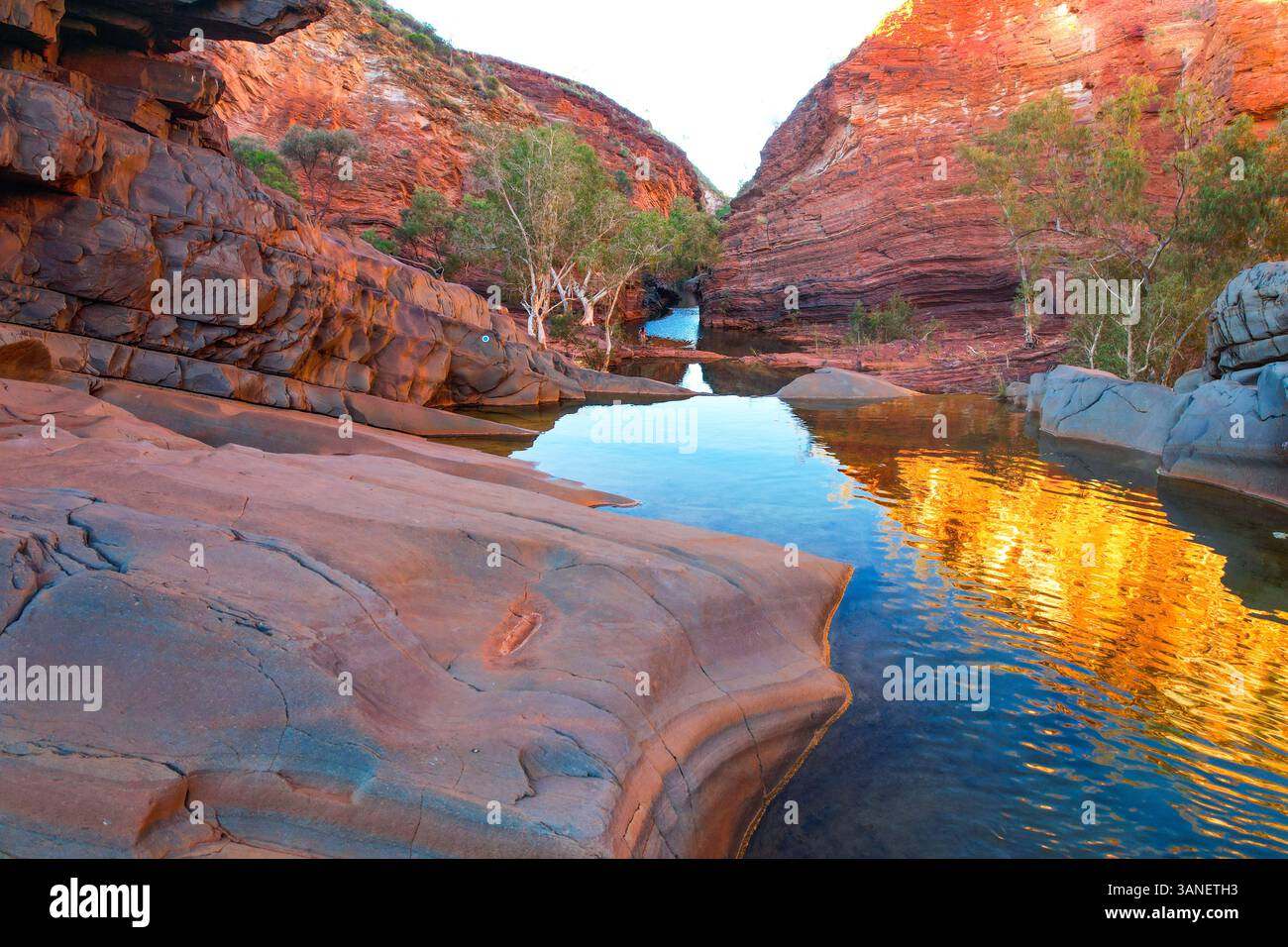 Aerial view of hamersley gorge with dramatic rock formations and tranquil water reflections ...
