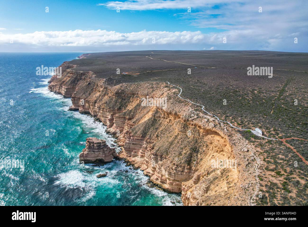 Aerial view of rugged cliffs and expansive ocean waves at Castle Cove ...