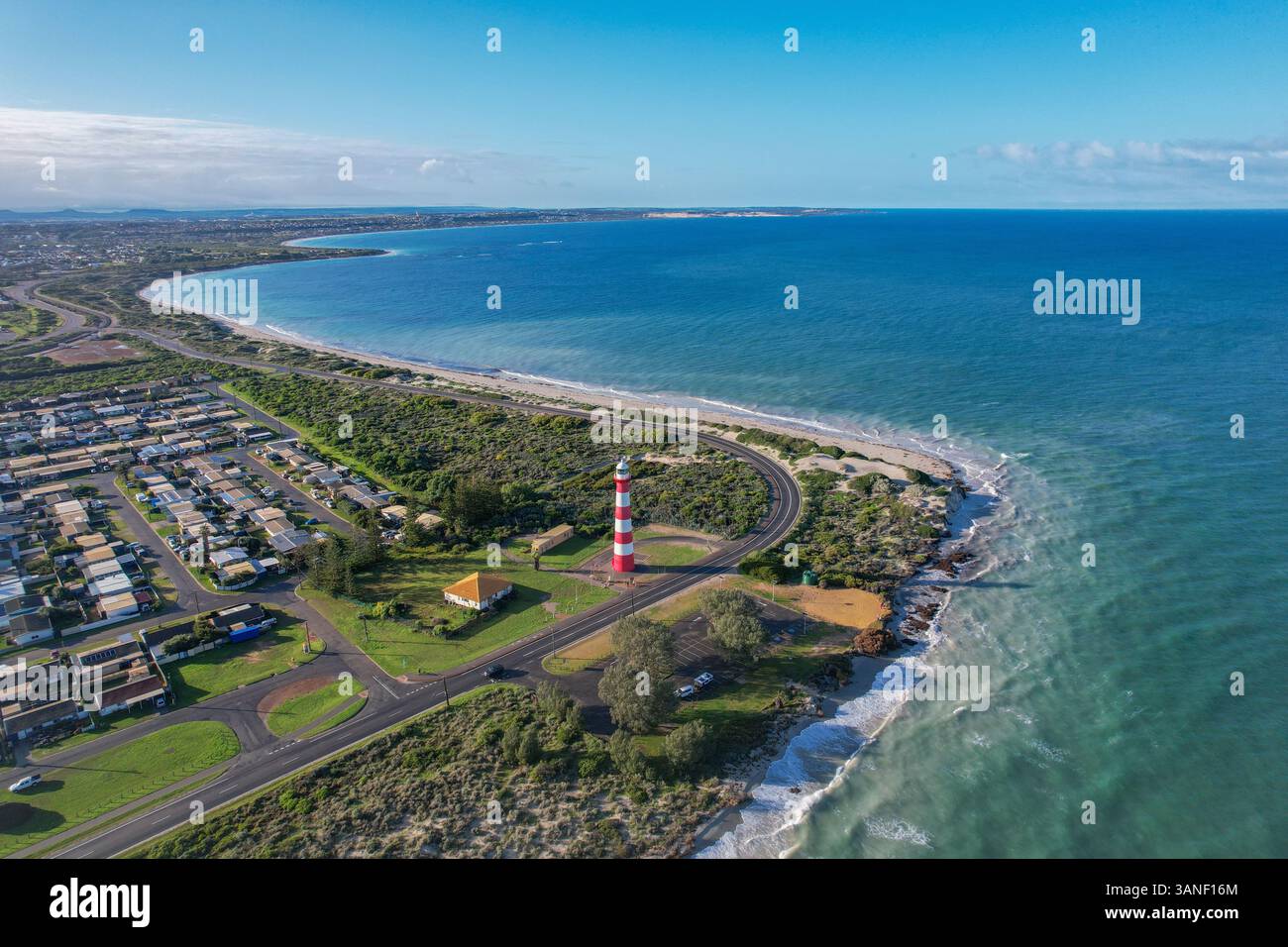 Aerial view of Point Moore Lighthouse and sandy coastline with houses ...