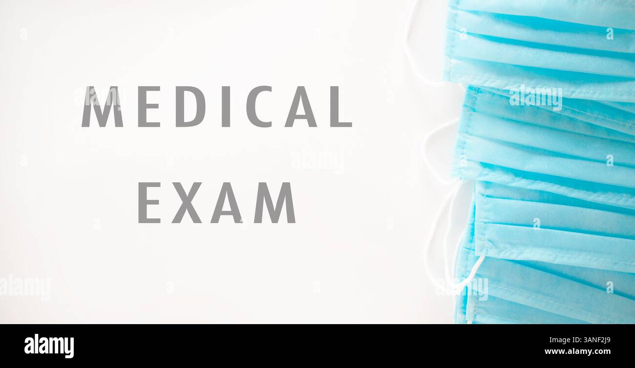 Stack of blue medical masks with the words medical exam written ...