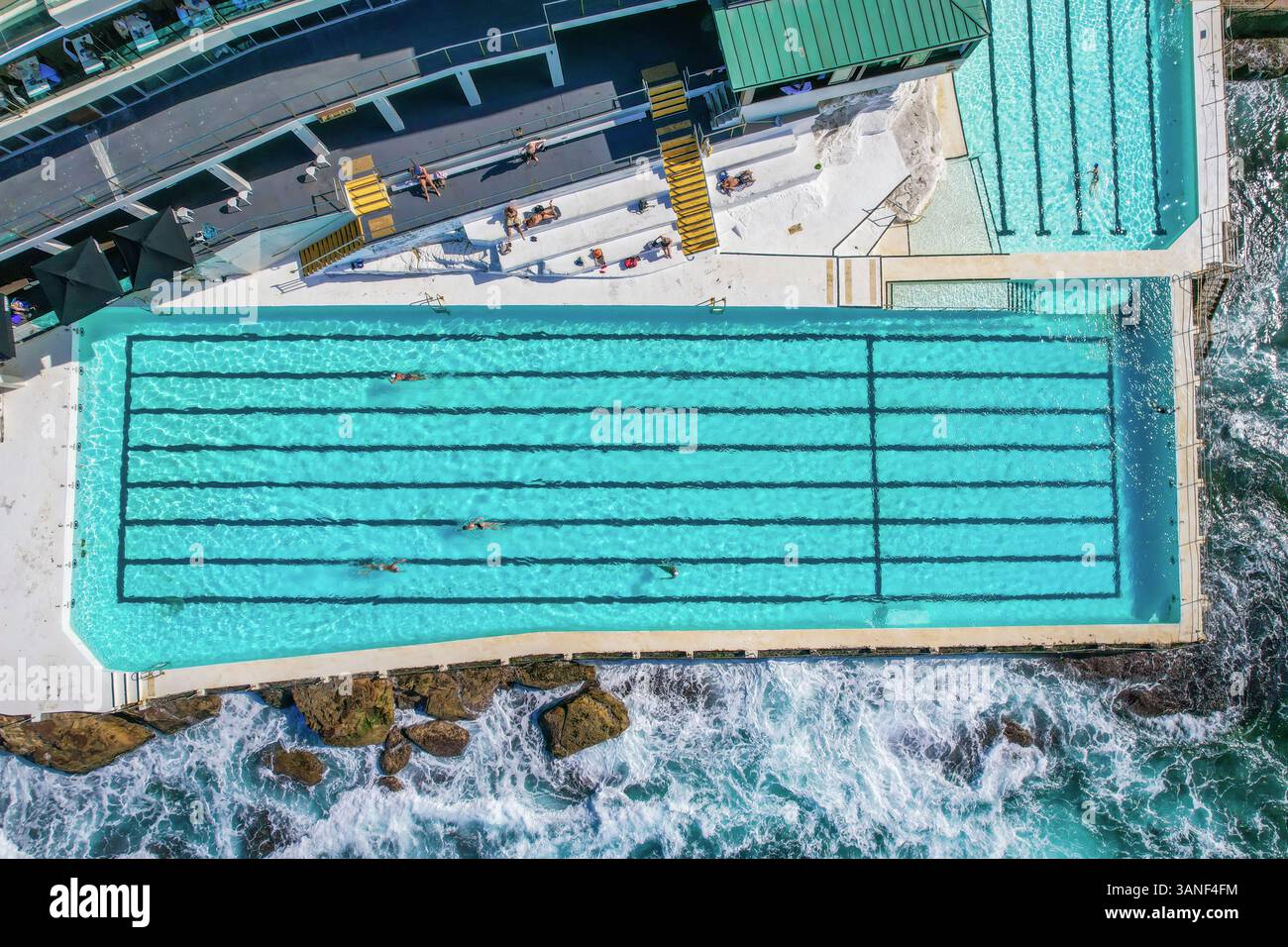 Aerial view of Bondi Icebergs Swimming Club and swimmers at oceanfront ...