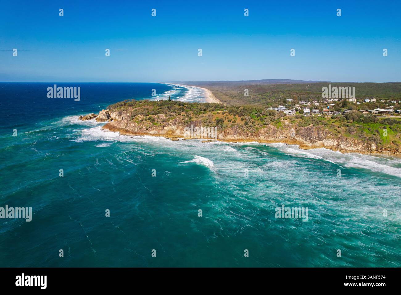 Aerial view of beautiful coastal cove with sandy beach and rocky cliffs ...