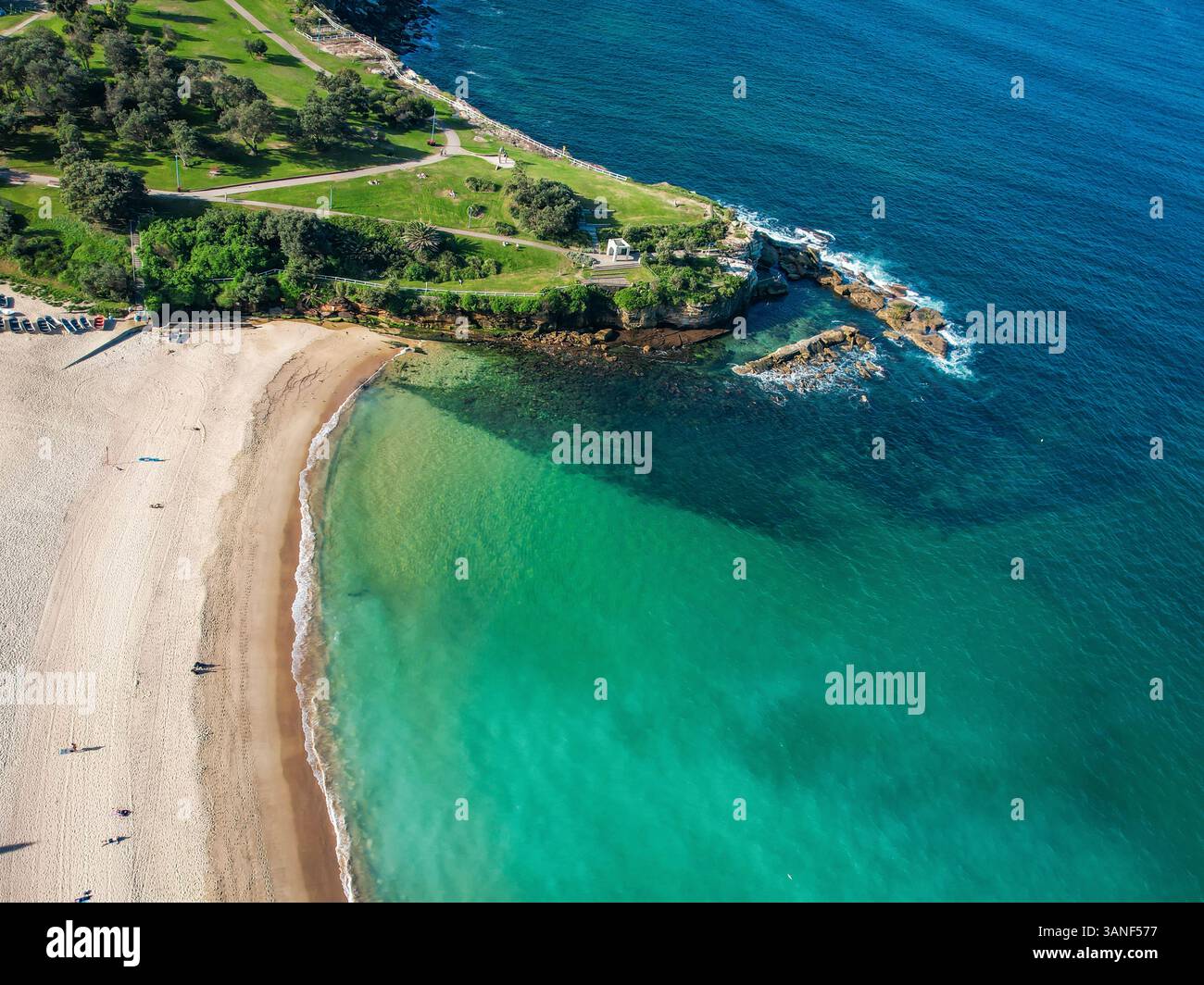 Aerial view of scenic Coogee Beach with rocky shore and green water ...