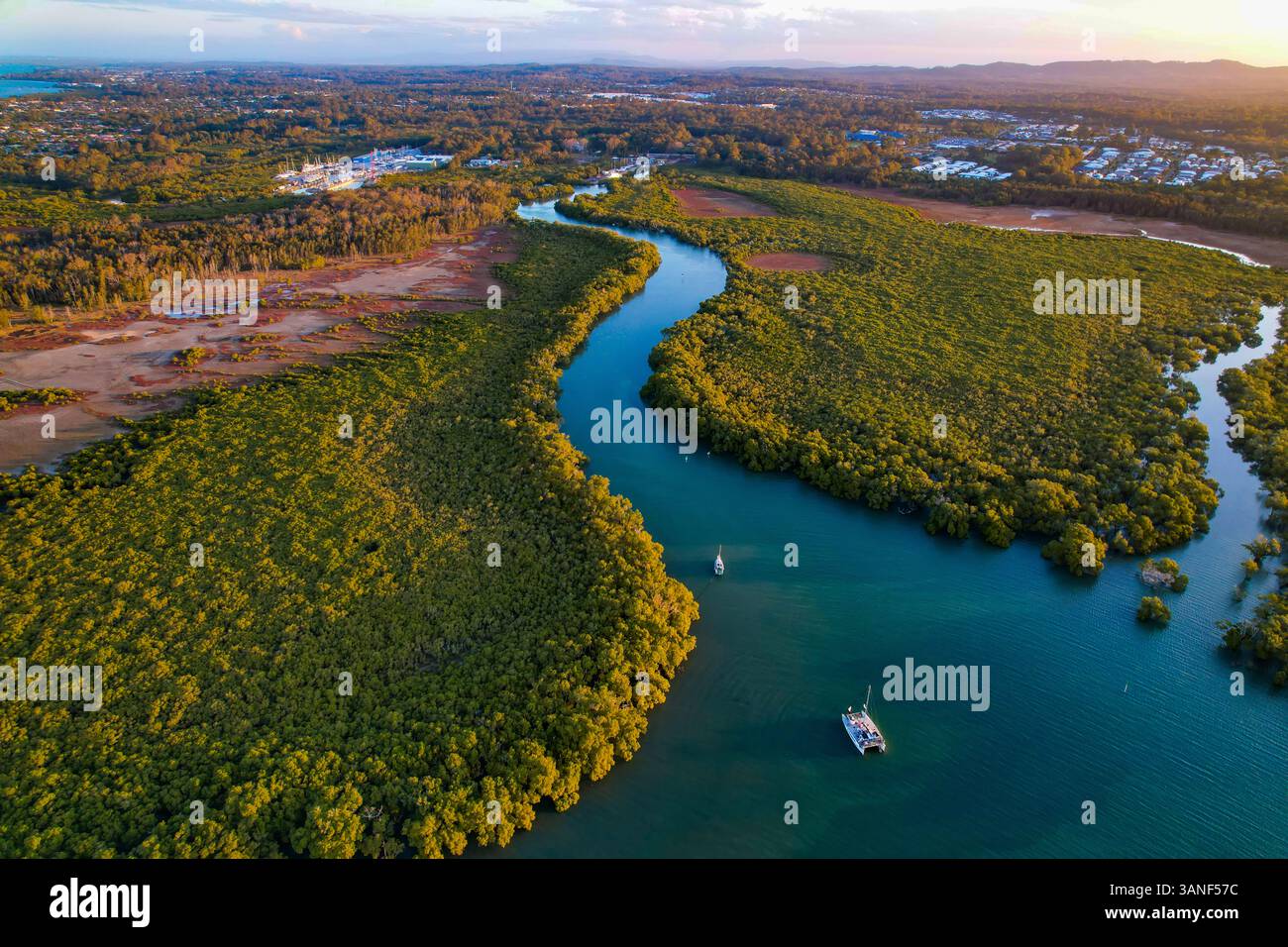 Aerial view of mangroves and boats along the river at sunset, Point ...