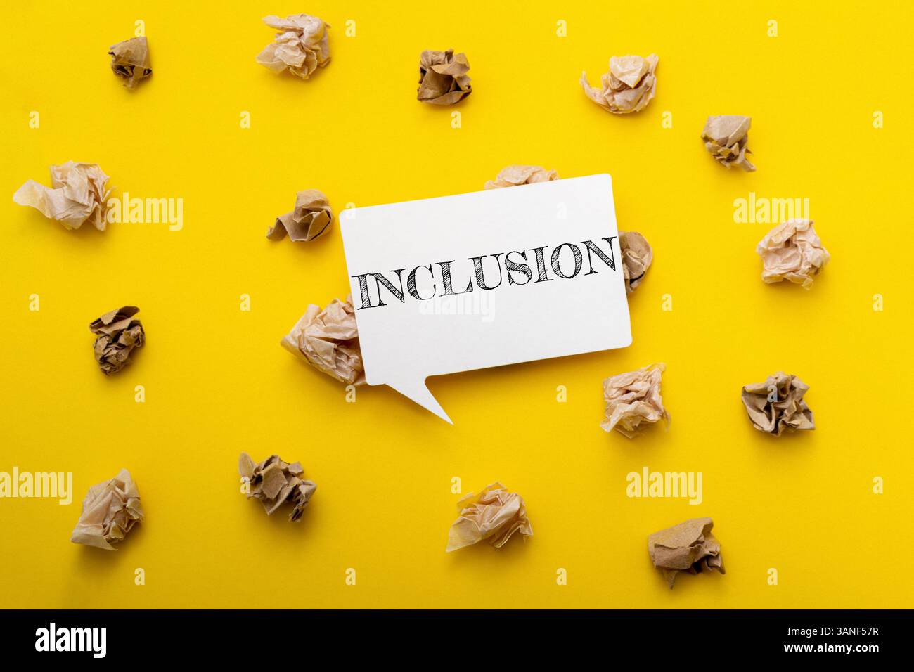 Yellow background with a white sign that says inclusion. The sign is ...