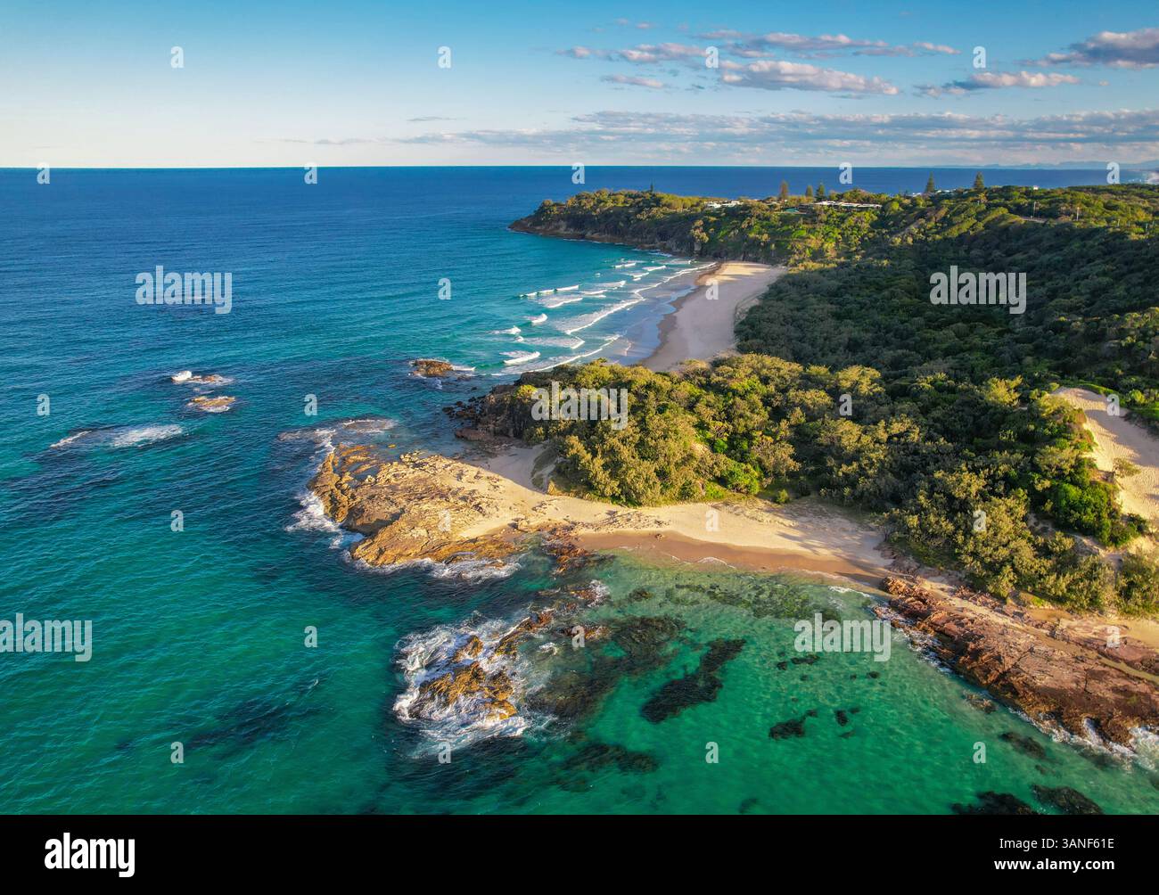 Aerial view of tropical beach with turquoise water and lush forest ...