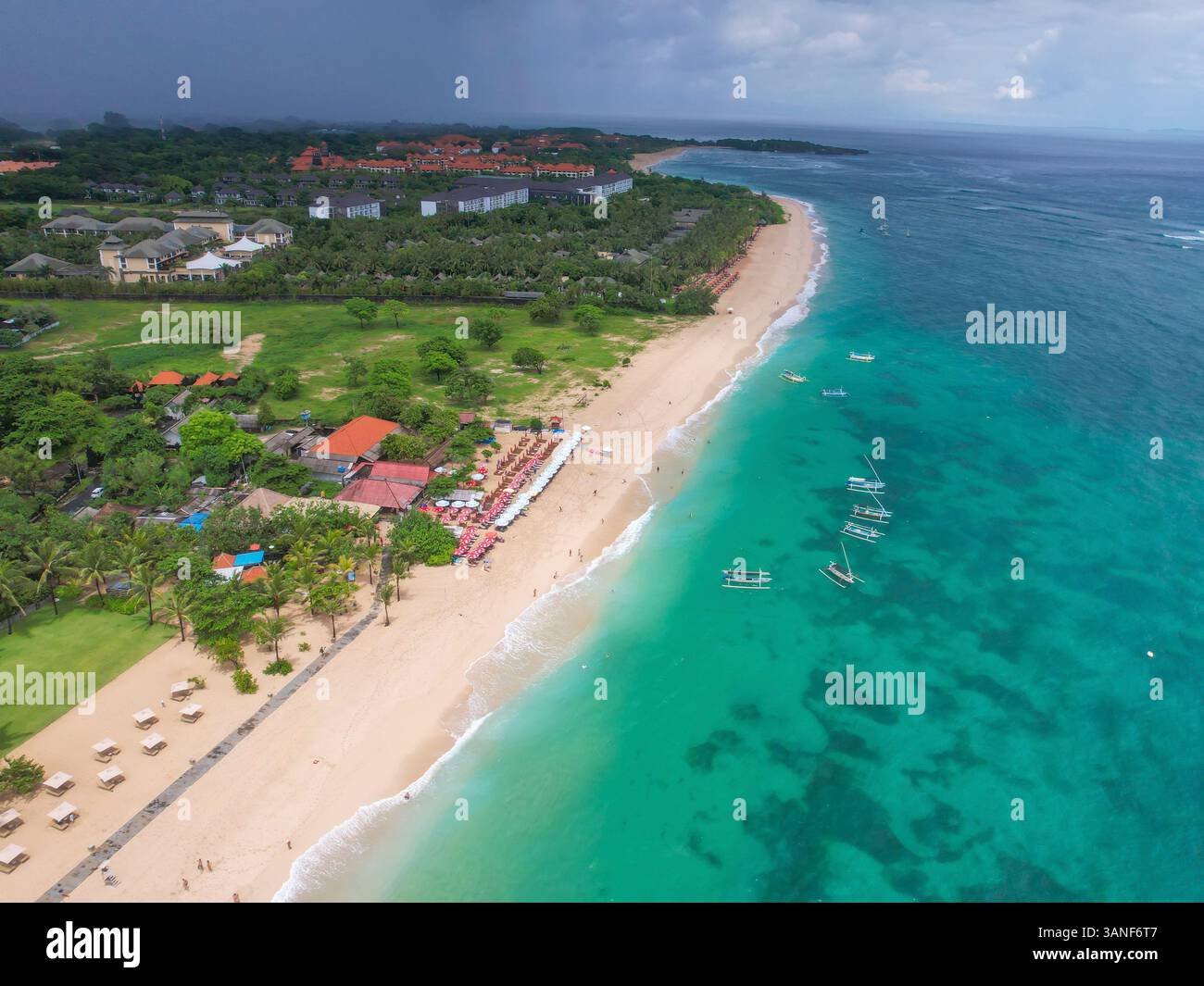 Aerial view of turquoise waters and sandy shore at Geger Beach, Nusa ...