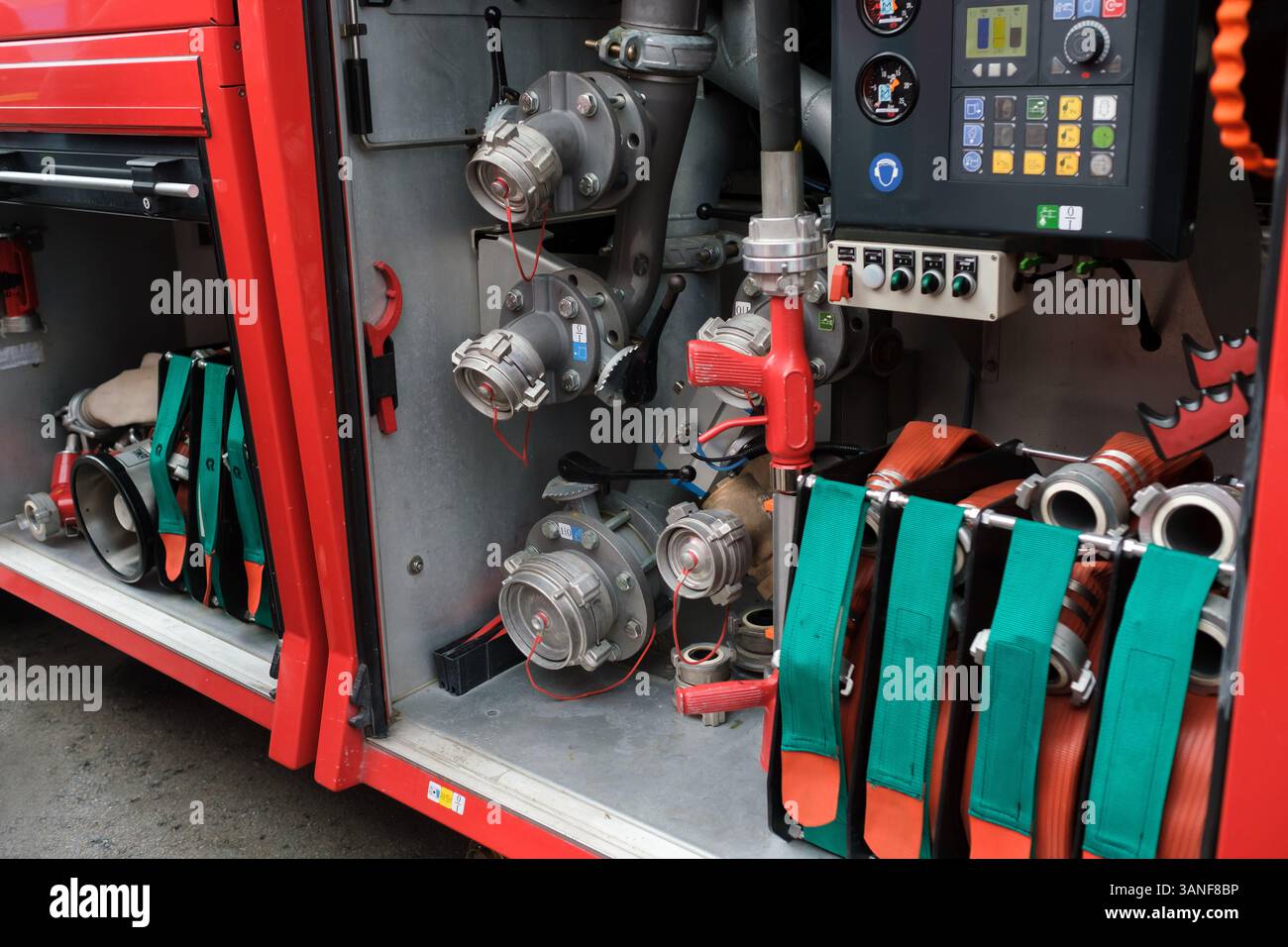 Firefighting equipment is displayed in a fire truck compartment, showcasing various hoses ...