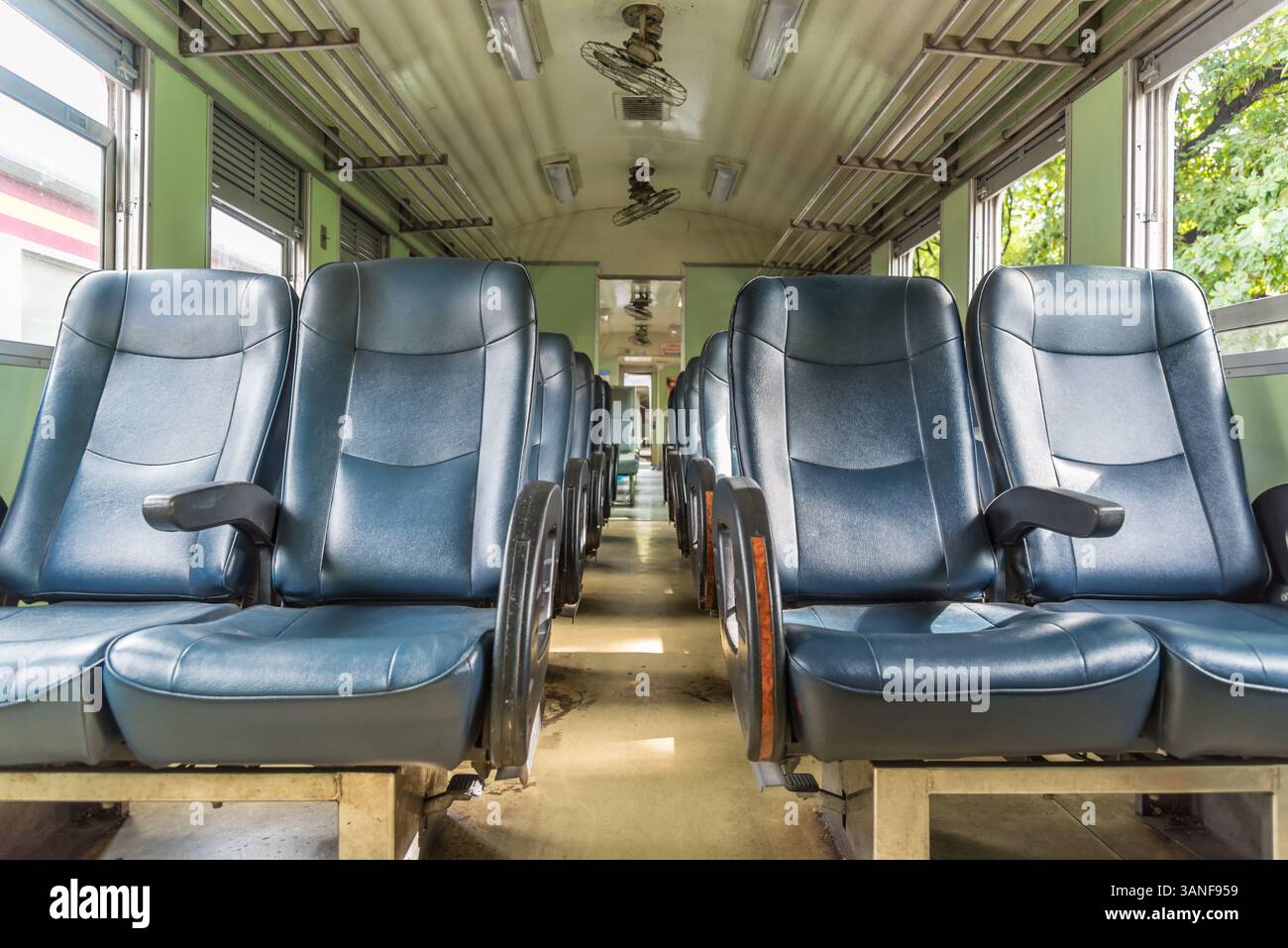 Inside of old public Thai railway train cabin with seats, handrails ...