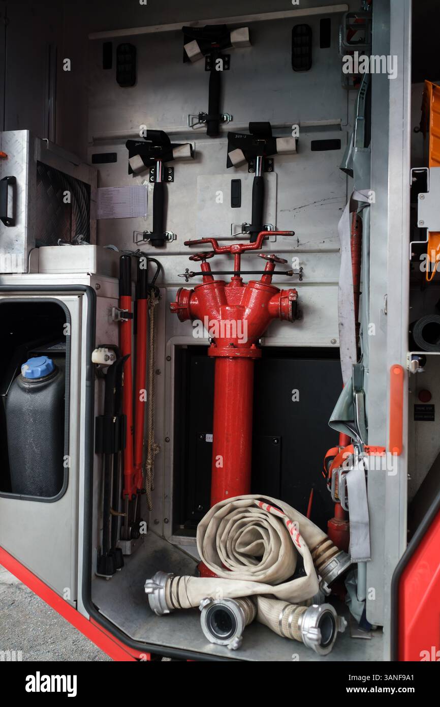 Fire truck equipment showcasing a red fire hydrant connection and hoses ...