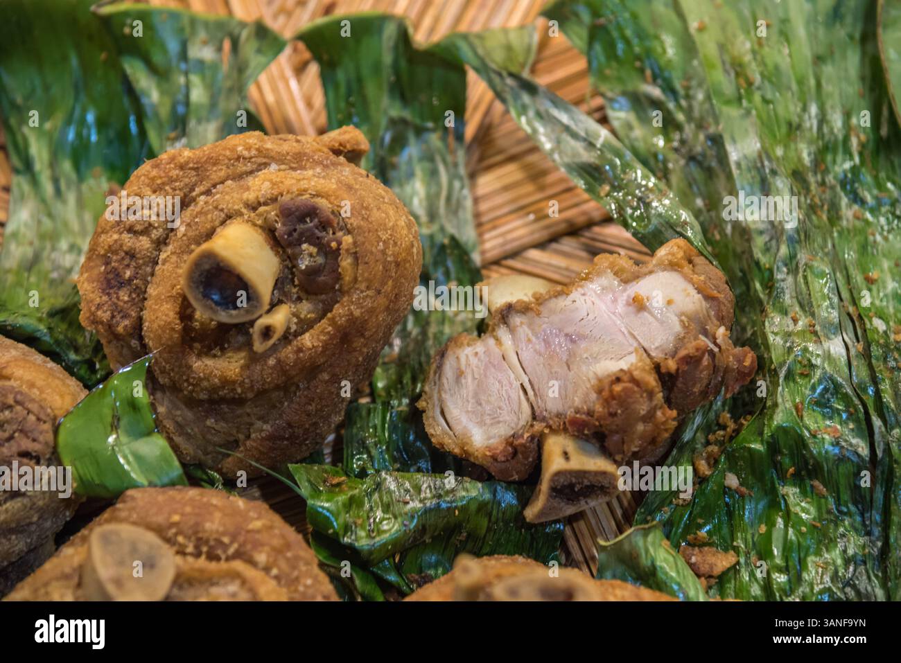 Crispy pork knuckle (Crispy Fried Pork Leg) in Thai traditional basket ...