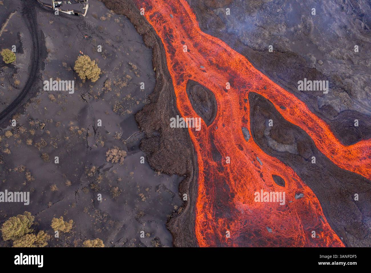 Aerial top down view of lava floating down the Volcan Cumbre Vieja, a ...