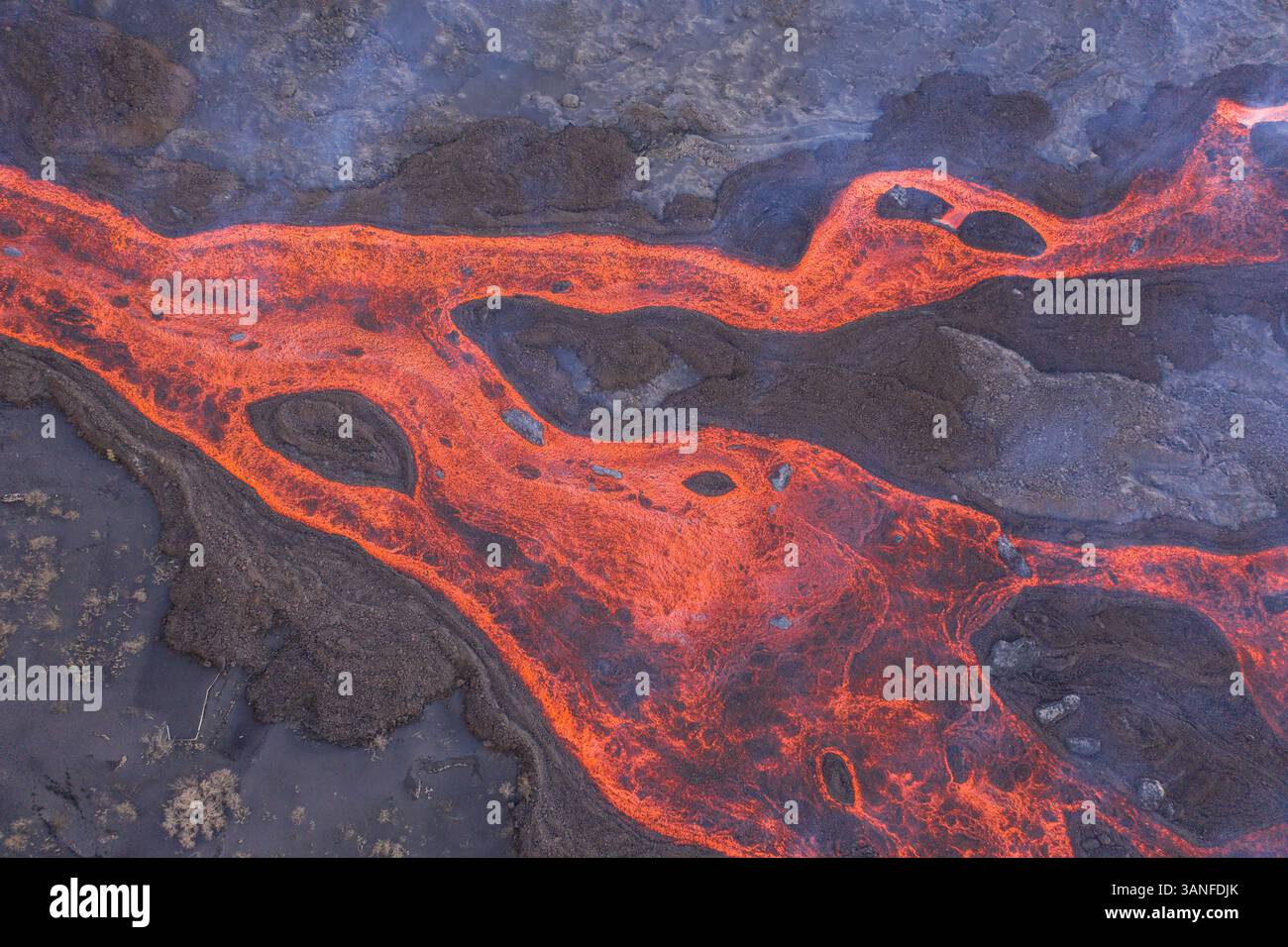 Aerial top down view of lava floating down the Volcan Cumbre Vieja, a ...