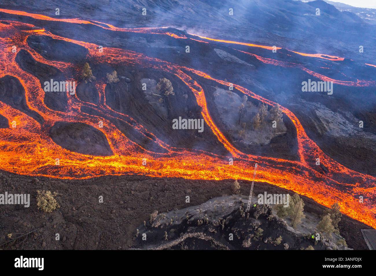 Aerial top down view of lava floating down the Volcan Cumbre Vieja, a ...
