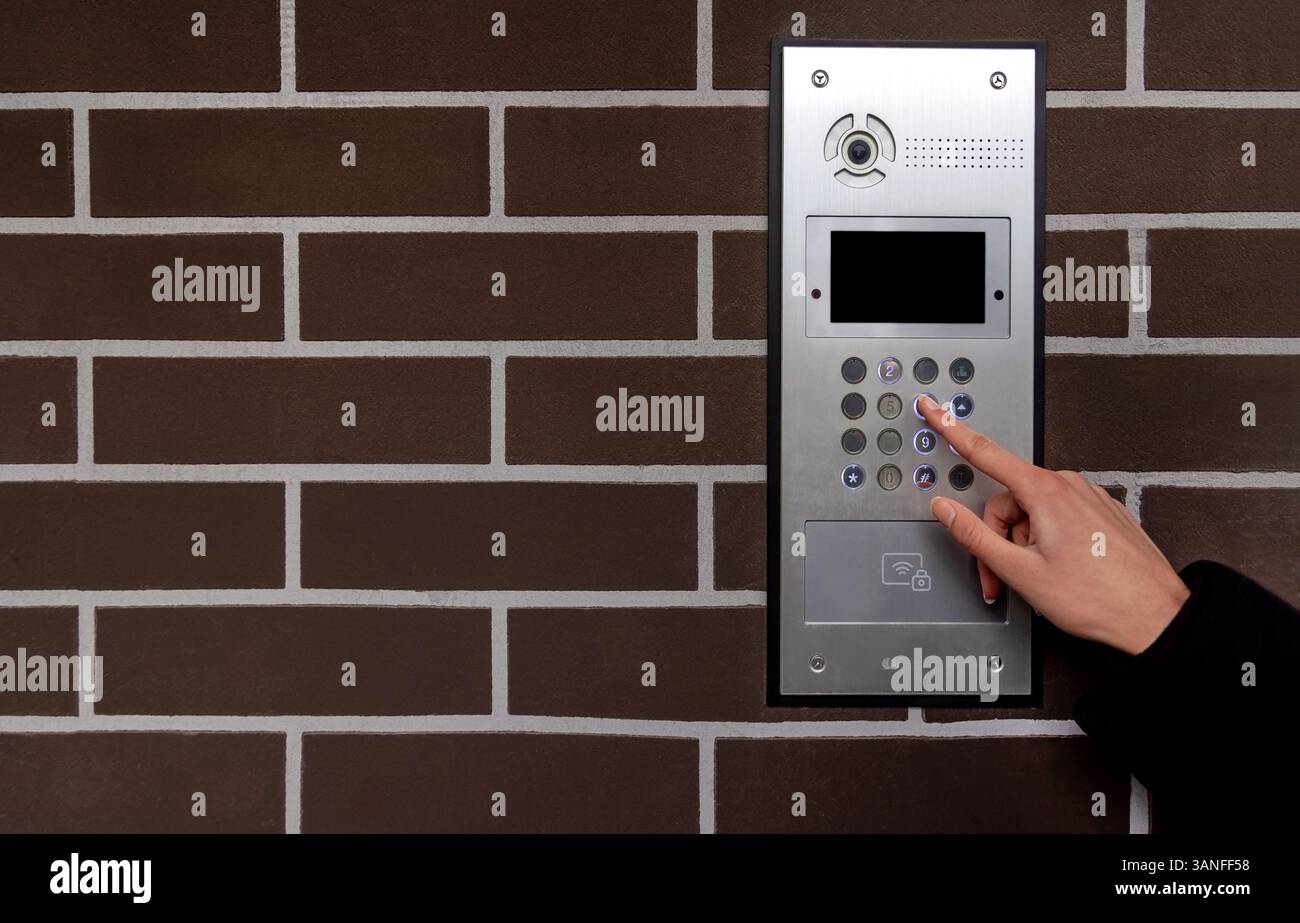 Hand entering code on keypad at building entrance. Space for text Stock ...