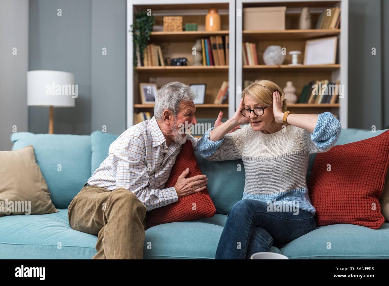 Elderly couple, talking and arguing in lounge, couch and discussion in ...