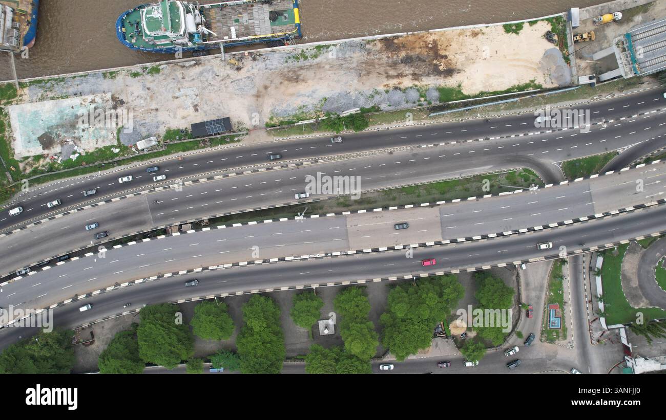 Aerial view of bustling urban landscape with busy highways, cars, and a ...