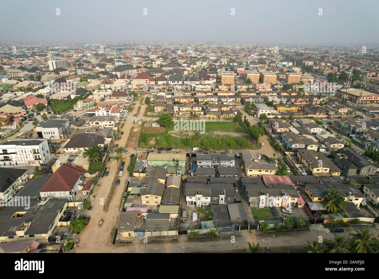 Aerial view of a bustling urban cityscape with dense residential buildings and rooftops, Lagos ...