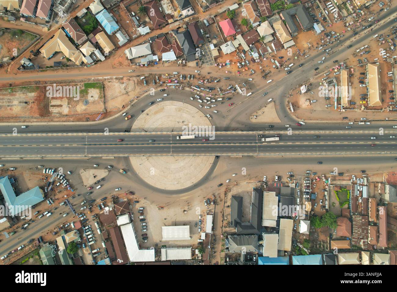 Aerial view of bustling urban cityscape with roads, roundabouts, and ...