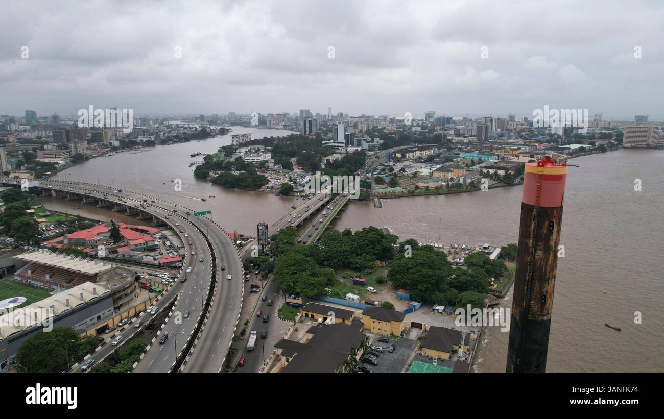 Aerial view of bustling urban landscape with modern architecture and a river crossing, Lagos ...