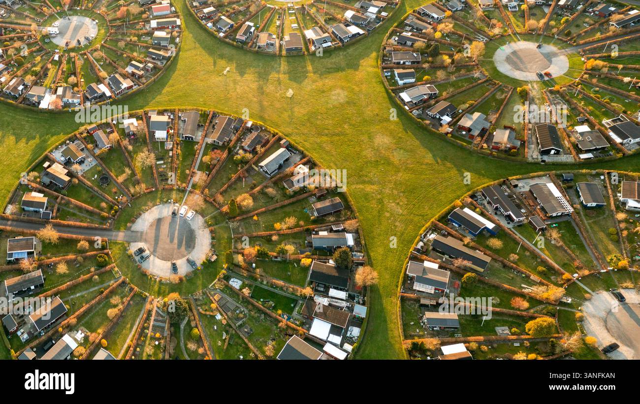Aerial view of circular housing and gardens in a planned community with ...