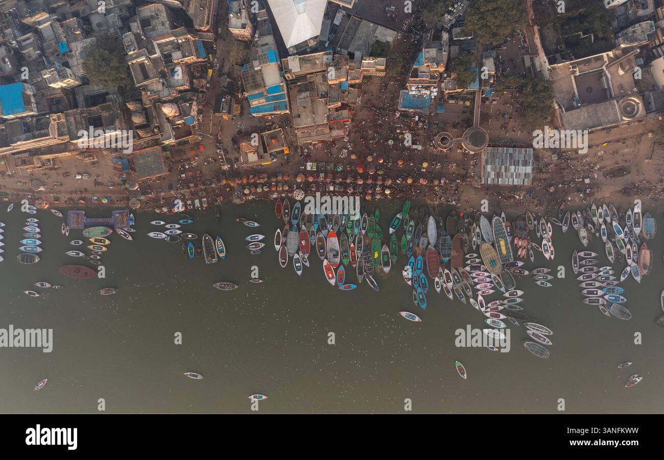 Aerial view of the bustling ghats along the Ganges river with colorful ...