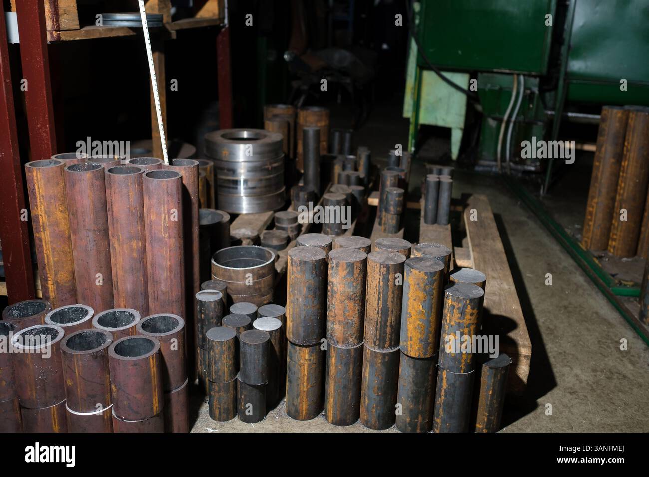 Collection of metal cylinders and pipes arranged in a workshop ...