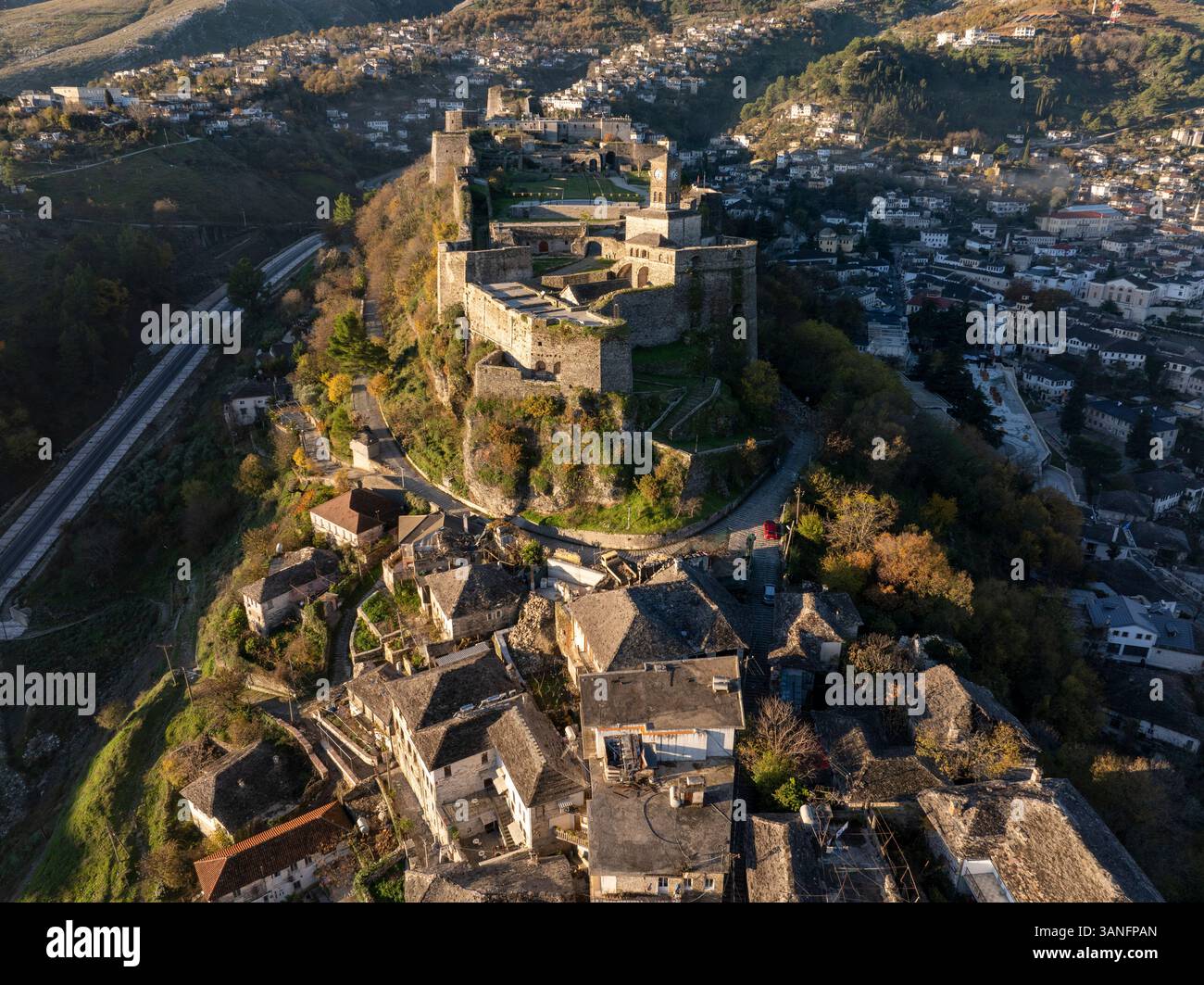 Aerial view of the historic castle of Gjirokaster at sunrise with ...