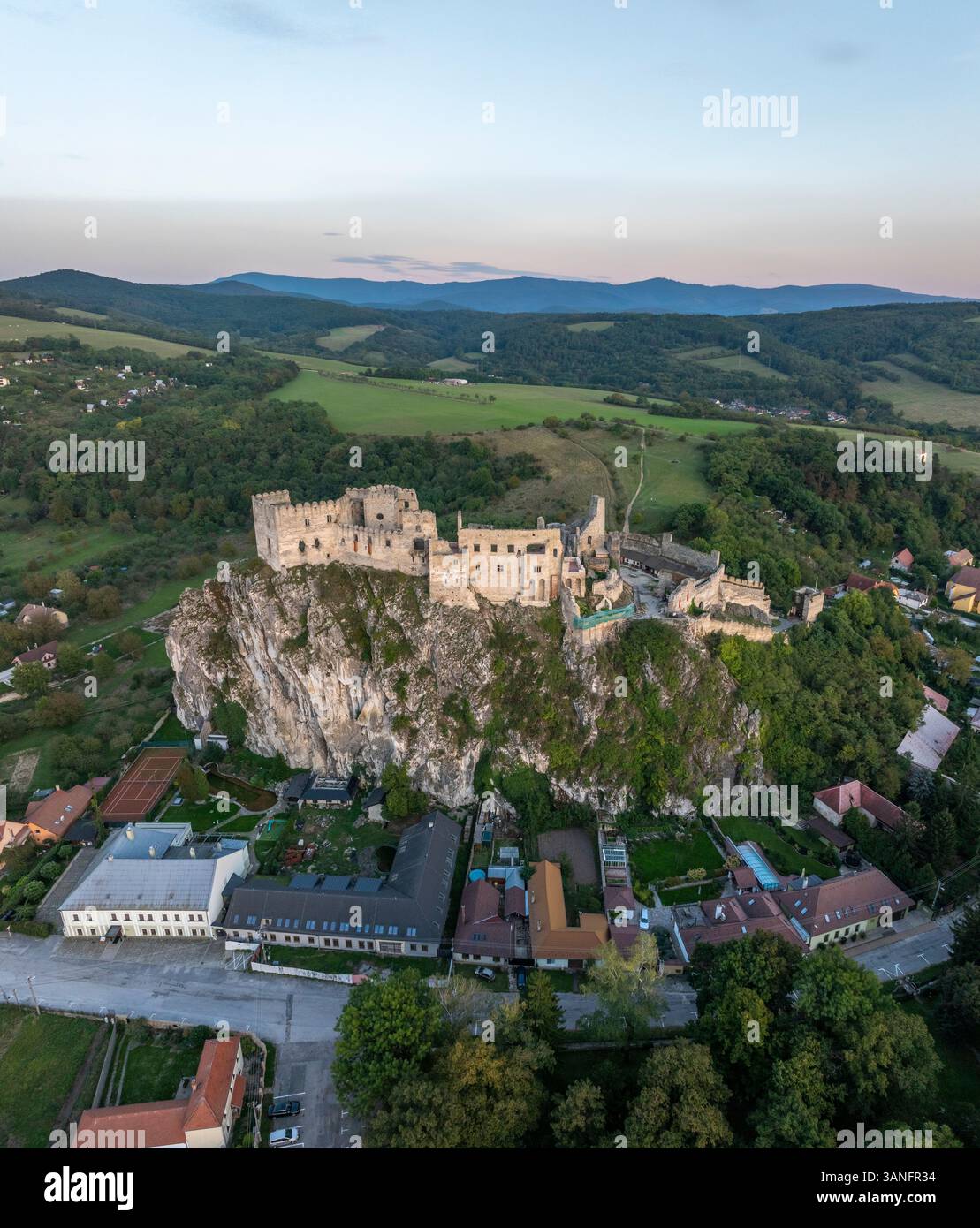 Aerial view of beckov castle at sunset surrounded by a small town and ...