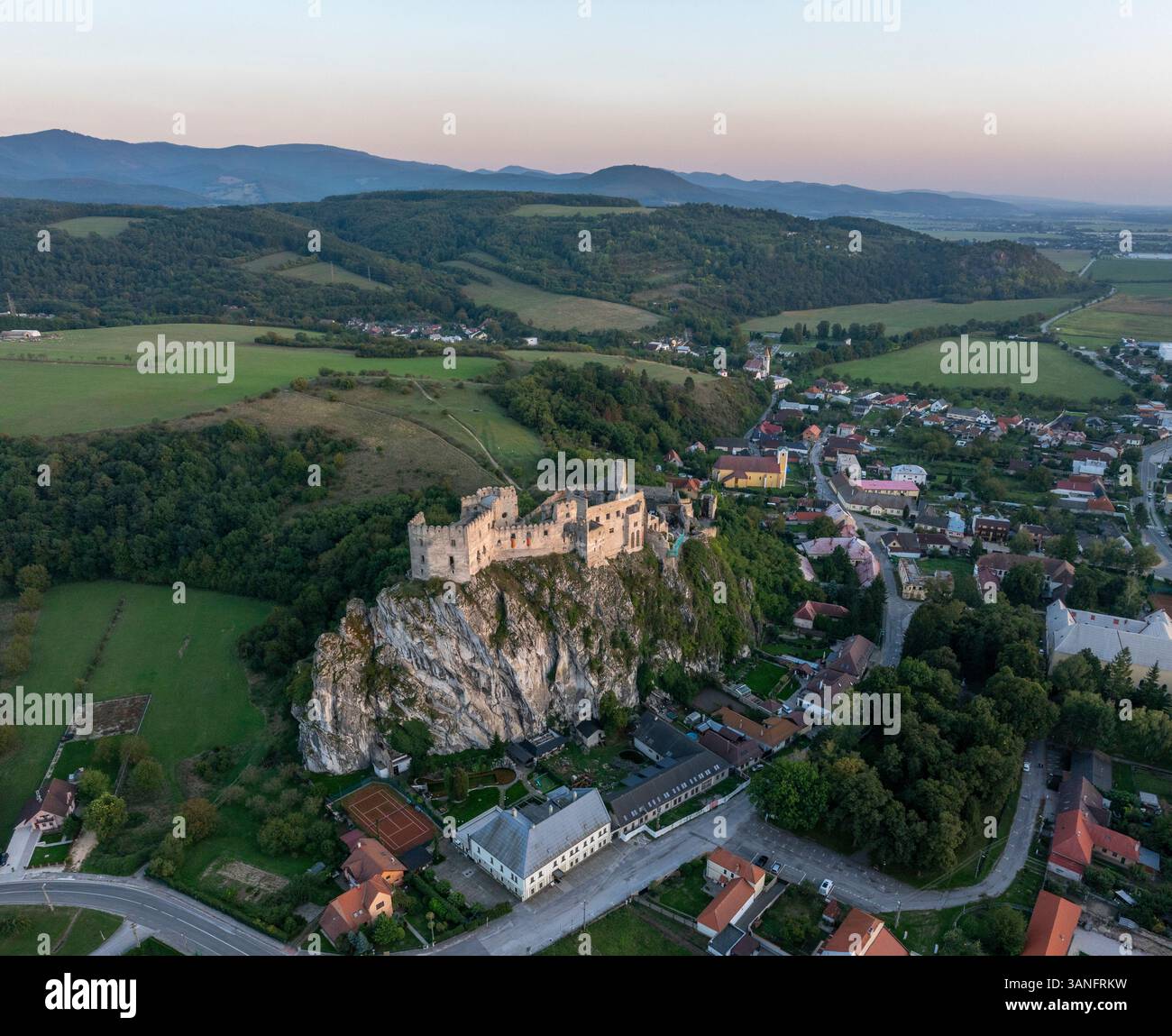 Aerial view of beckov castle at sunset with surrounding village and ...