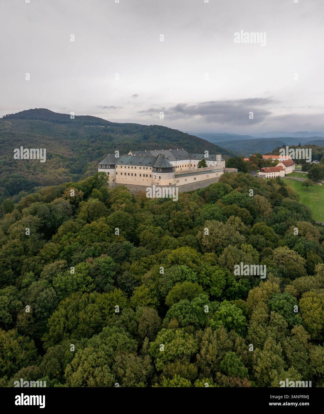 Aerial view of Cerveny Kamen Castle surrounded by lush forest and ...