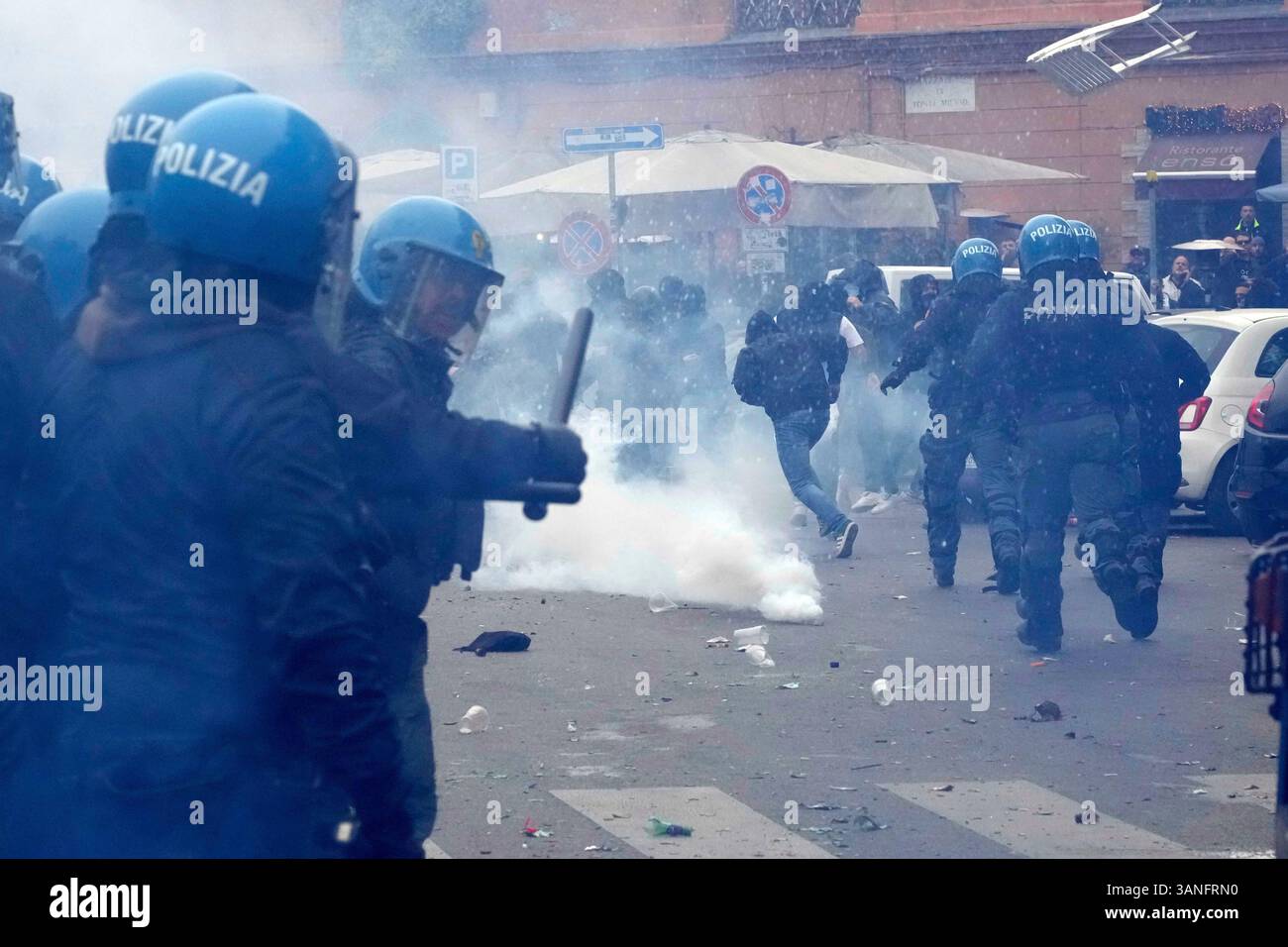Lazio fans clash with Italian Policemen in riot gear outside the ...