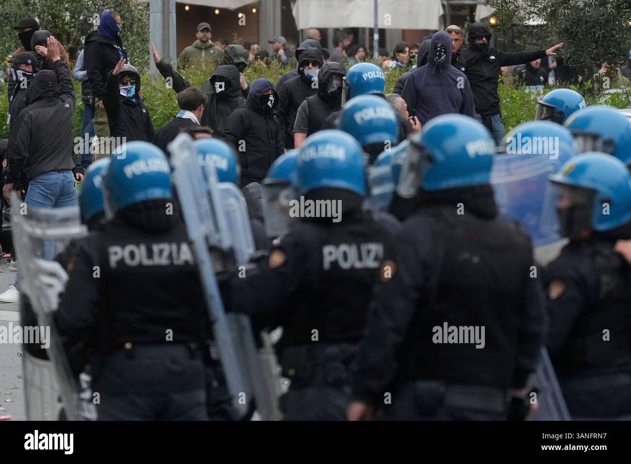 Lazio fans clash with Italian Policemen in riot gear outside the ...