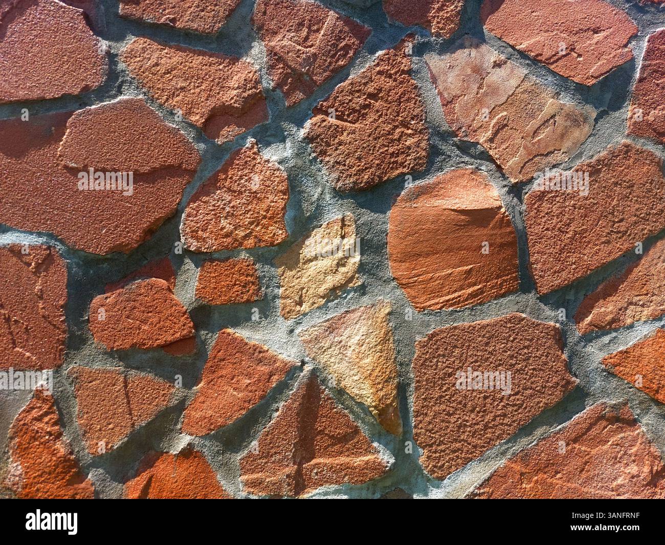 Explore the Unique Texture of a Red Natural Stone Wall Featuring Rich ...