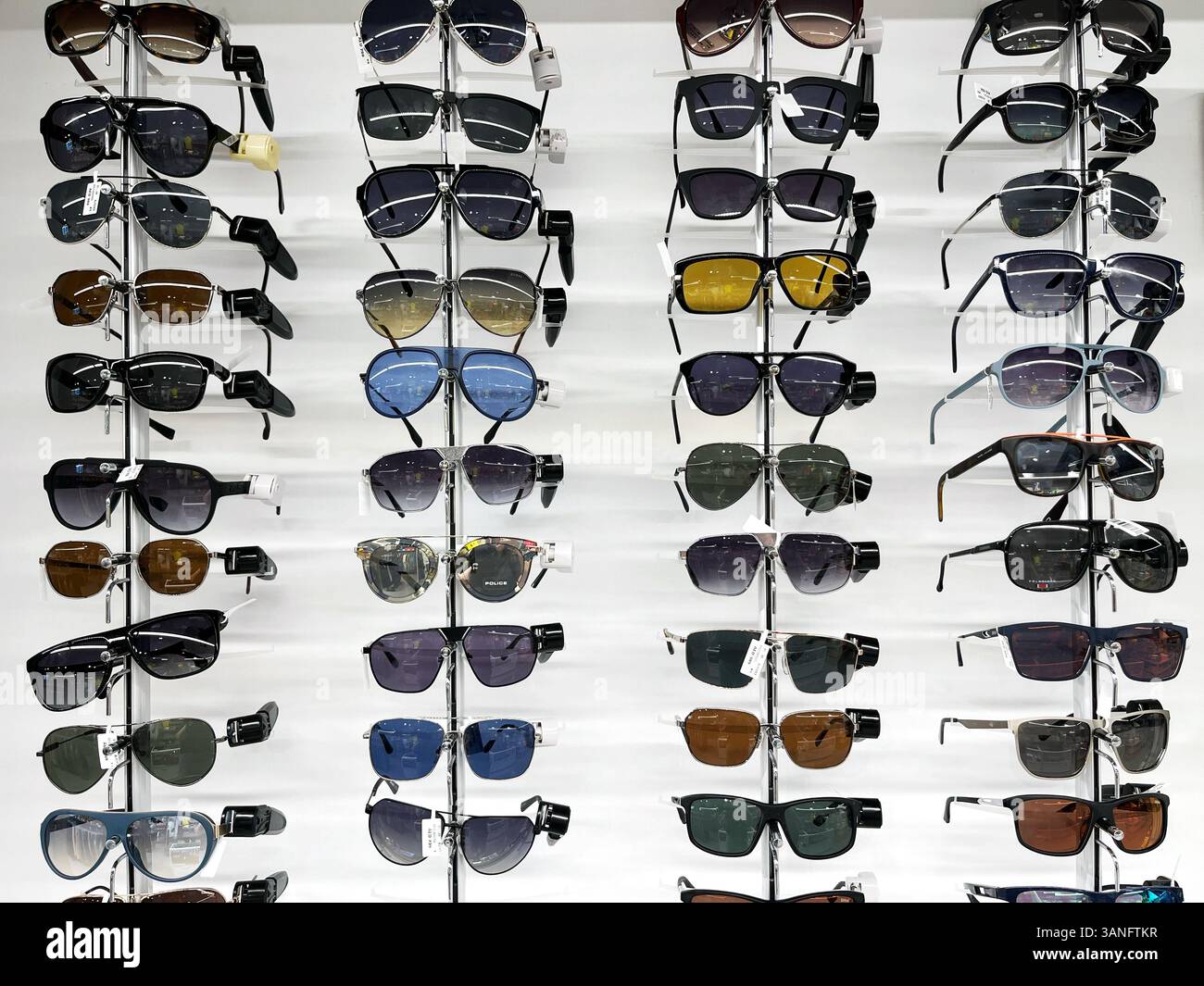 Display of a range of sunglasses on a shelf in an optical store. Dubai ...
