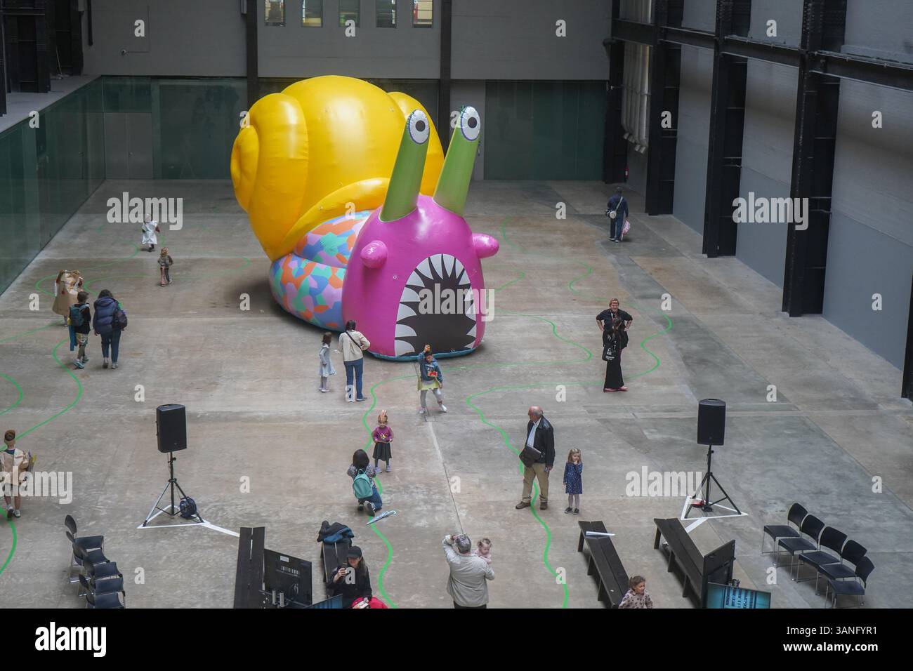 London UK 15 April 2025. Visitors interact with a larger-than-life ...