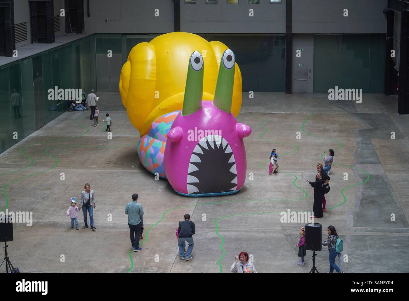 London UK 15 April 2025. Visitors interact with a larger-than-life ...