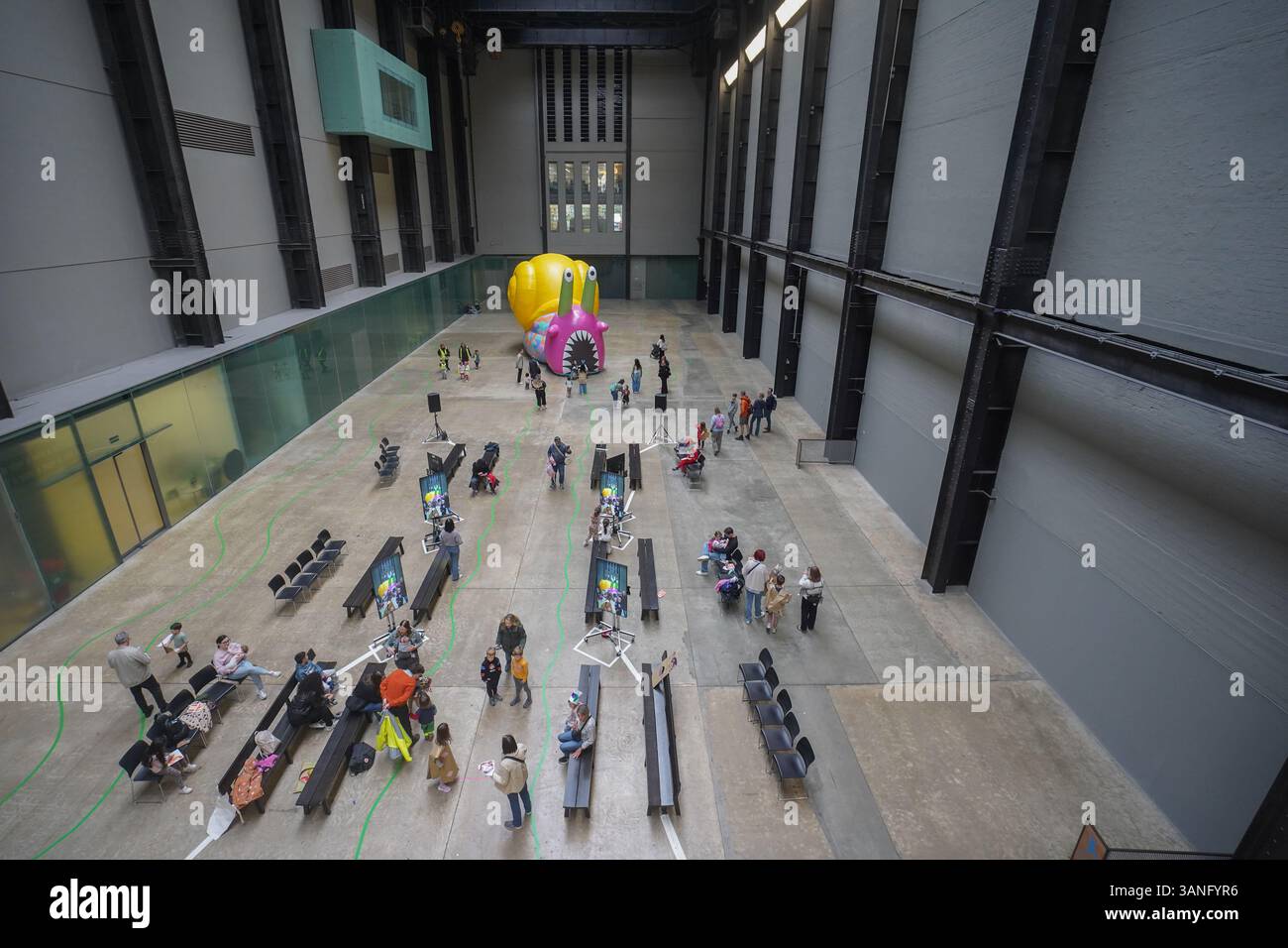 London UK 15 April 2025. Visitors interact with a larger-than-life ...
