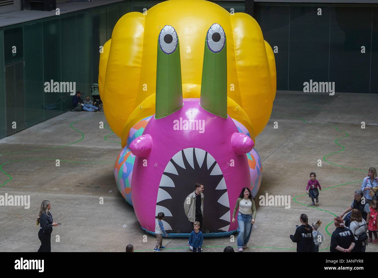 London UK 15 April 2025. Visitors interact with a larger-than-life ...
