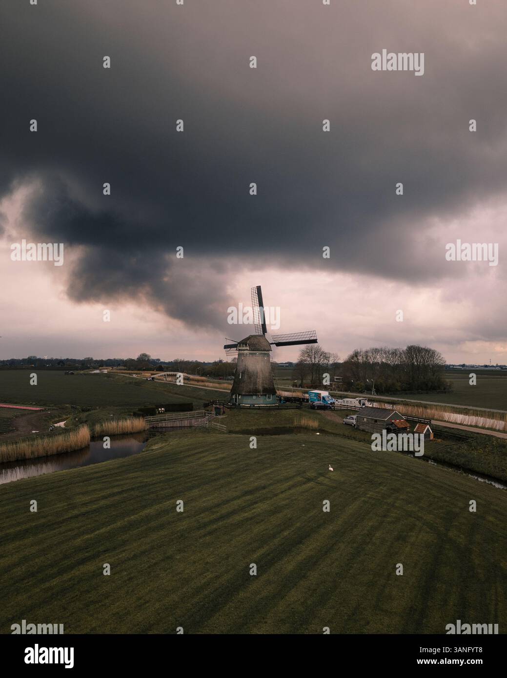 Aerial view of a historic windmill under a dark sky with dramatic ...