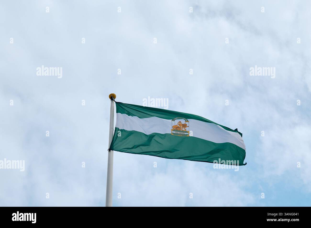 Flag of Andalusia under the sky Stock Photo - Alamy